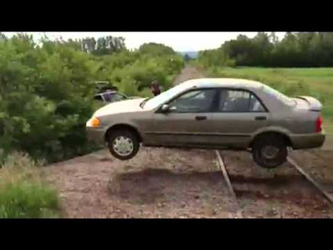 Thrill Seekers Launch a Car Over Railroad Tracks & Plow It Into an RV