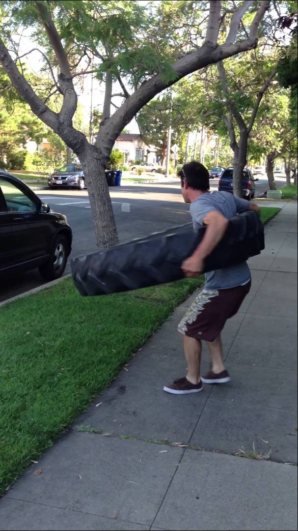 Man Hula Hoops 98 Pound Tractor Tire