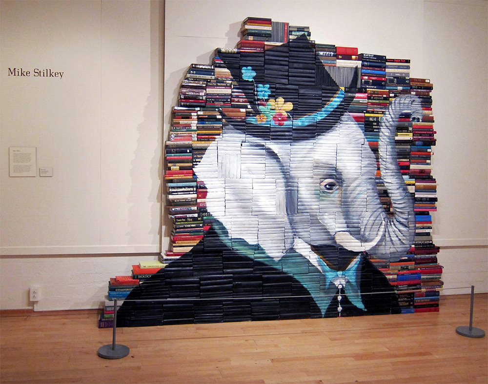Character Art Painted on Stacks of Books by Mike Stilkey