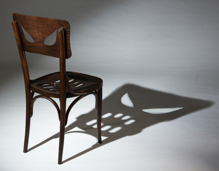 The Pet Chair, A Wooden Chair That Casts the Silhouette of a Menacing Face
