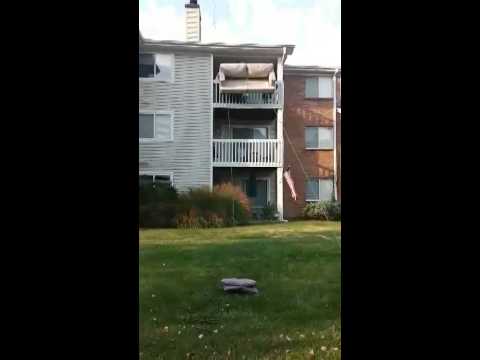 Couch Moved From Third Story Balcony With a Rigged System of Wires