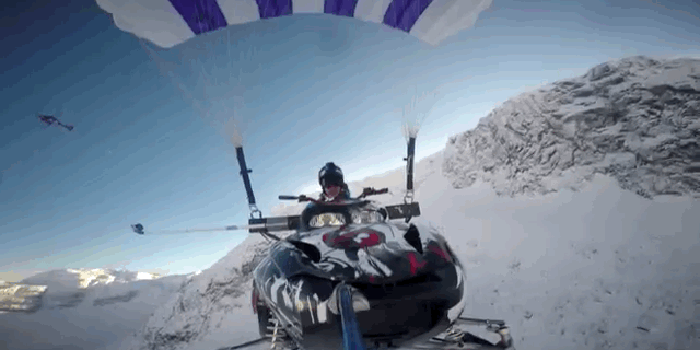 A Daredevil Blissfully Glides Off the Side of a Mountain on a ...