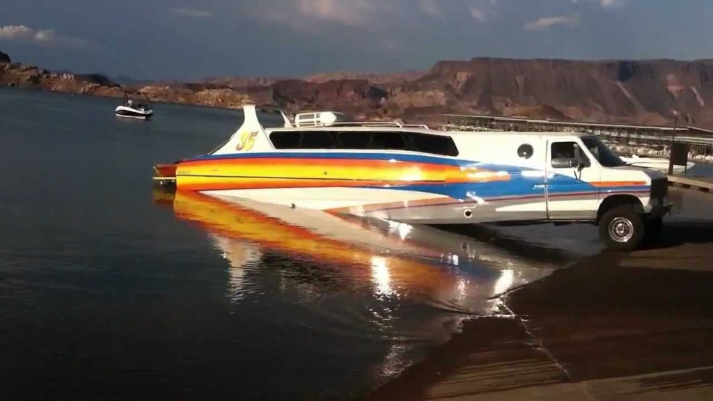 A Unique RV/Boat Hybrid 'BoaterHome' Vehicle Launches at a Boat Ramp in ...