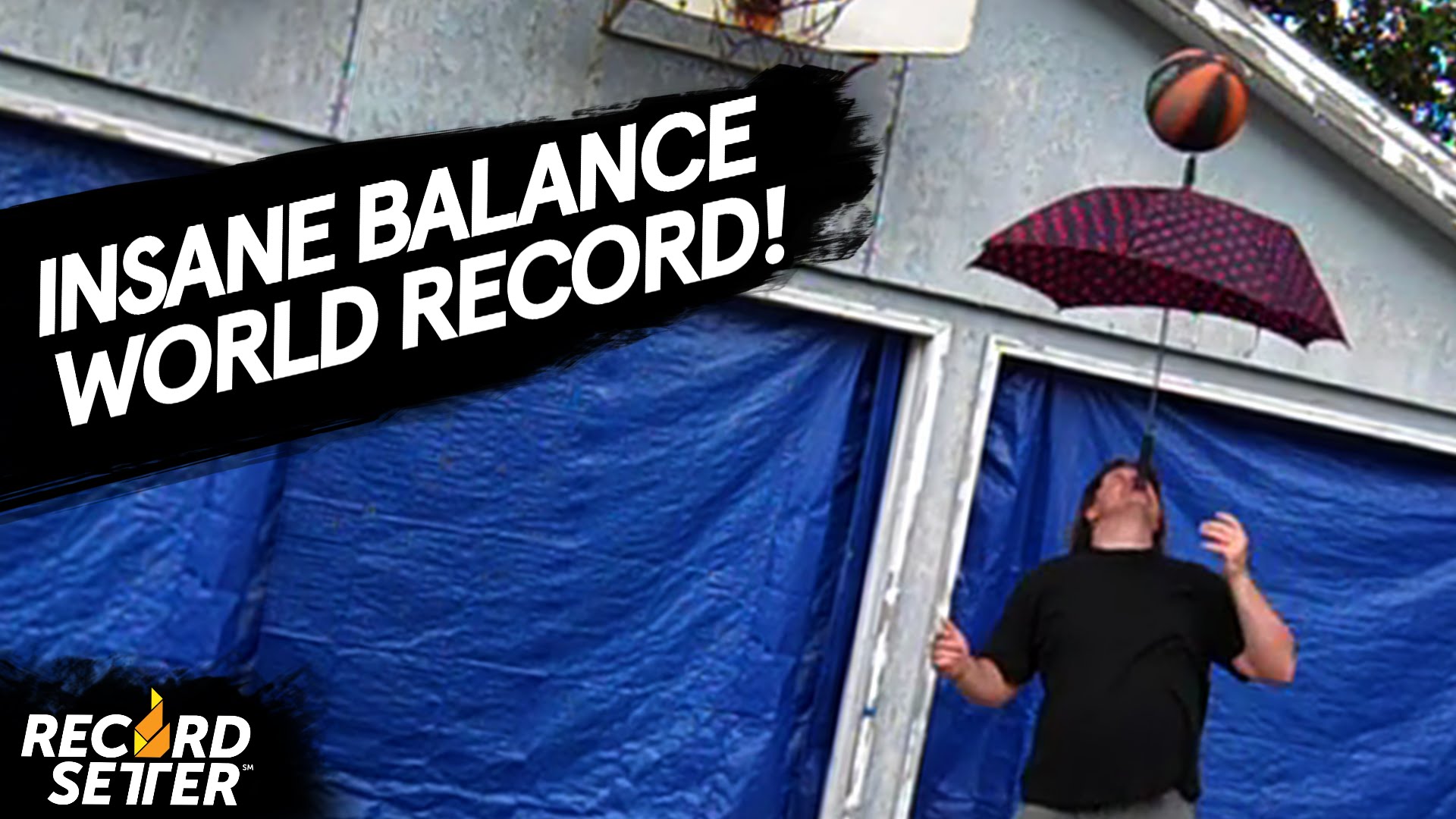 Man Spins a Basketball on Top of an Open Umbrella While Balancing It on ...