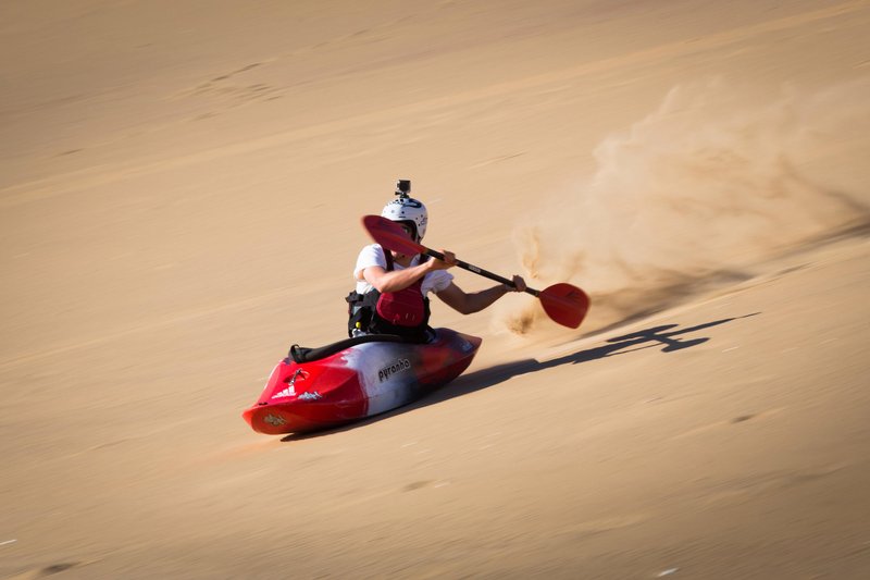 A Kayaker Rides Down Sand Dunes in Namibia