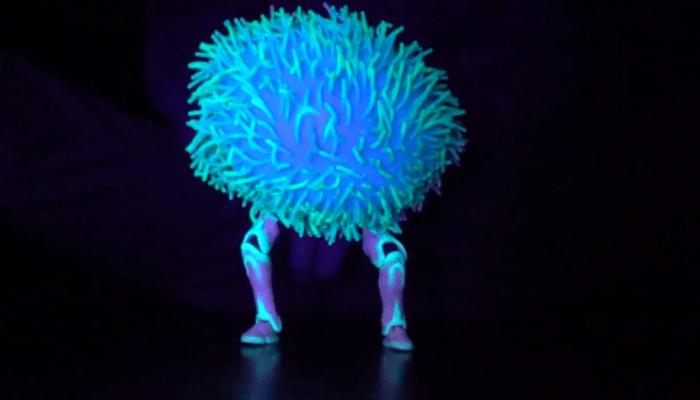 A Lively Glowing Bug Puppet Dances Upon Drum Pads That Provide Musical