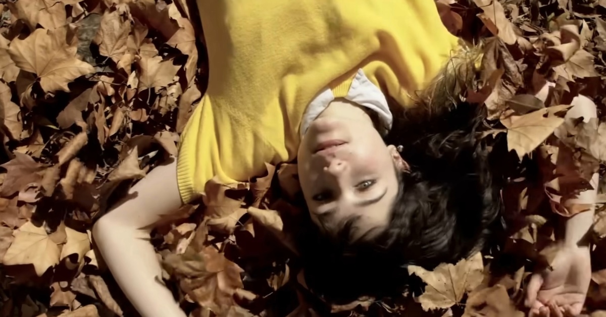 Dancers in Yellow Frolic Around the Woods in the Official Music Video ...