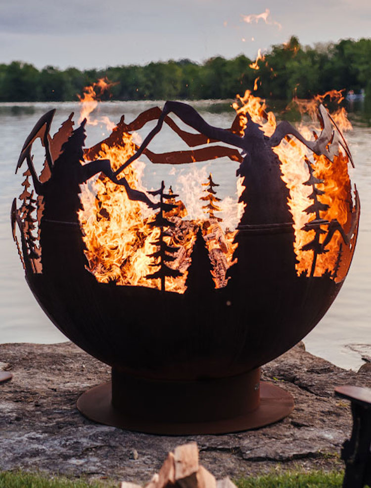 A Sturdy Steel Backyard Fire Pit Globe With a Detailed Forest ...