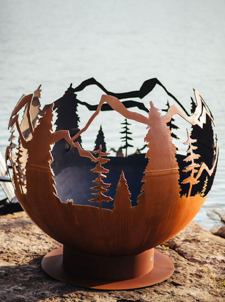 A Sturdy Steel Backyard Fire Pit Globe With a Detailed Forest ...