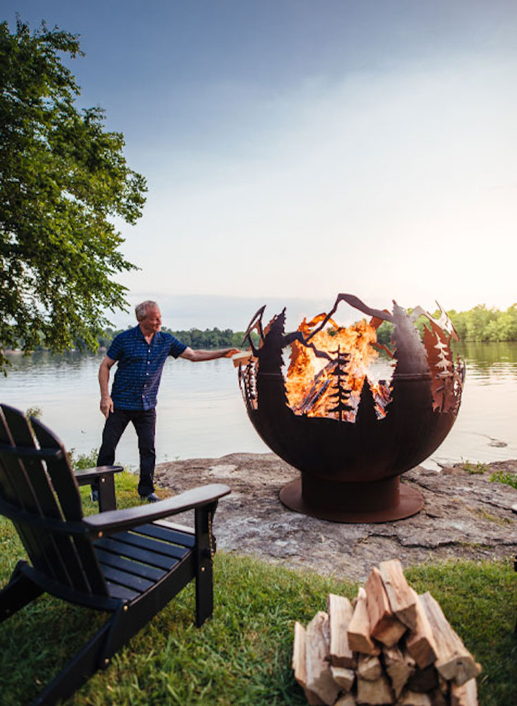 A Sturdy Steel Backyard Fire Pit Globe With a Detailed Forest ...