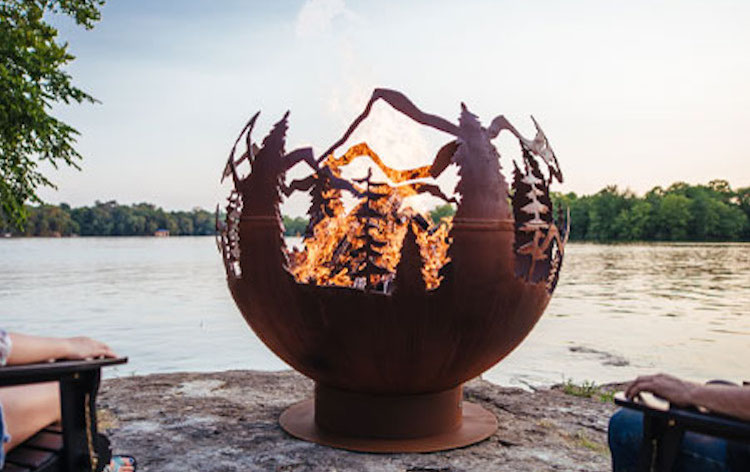 A Sturdy Steel Backyard Fire Pit Globe With a Detailed Forest ...