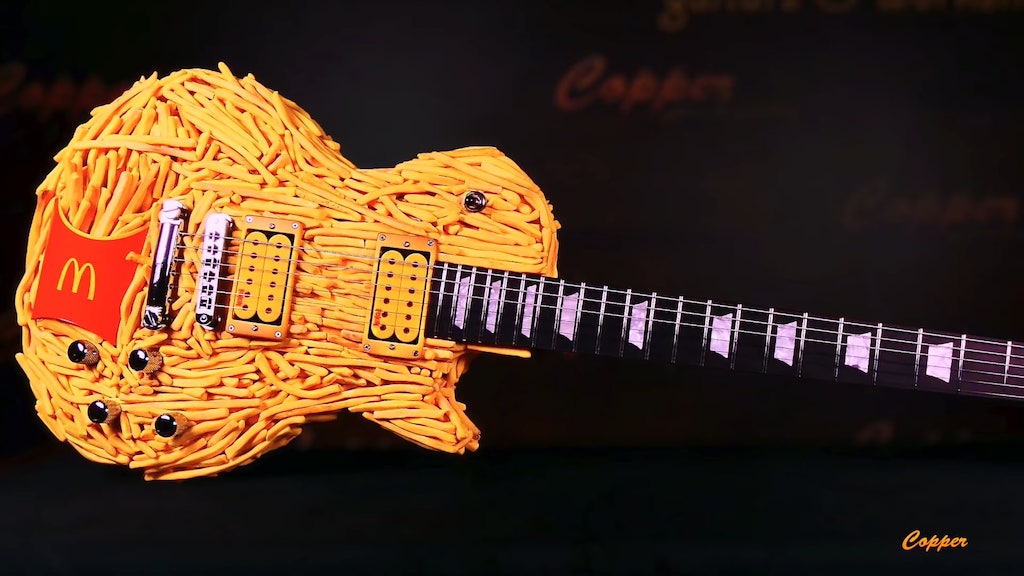 An Electric Guitar Made Out of French Fries